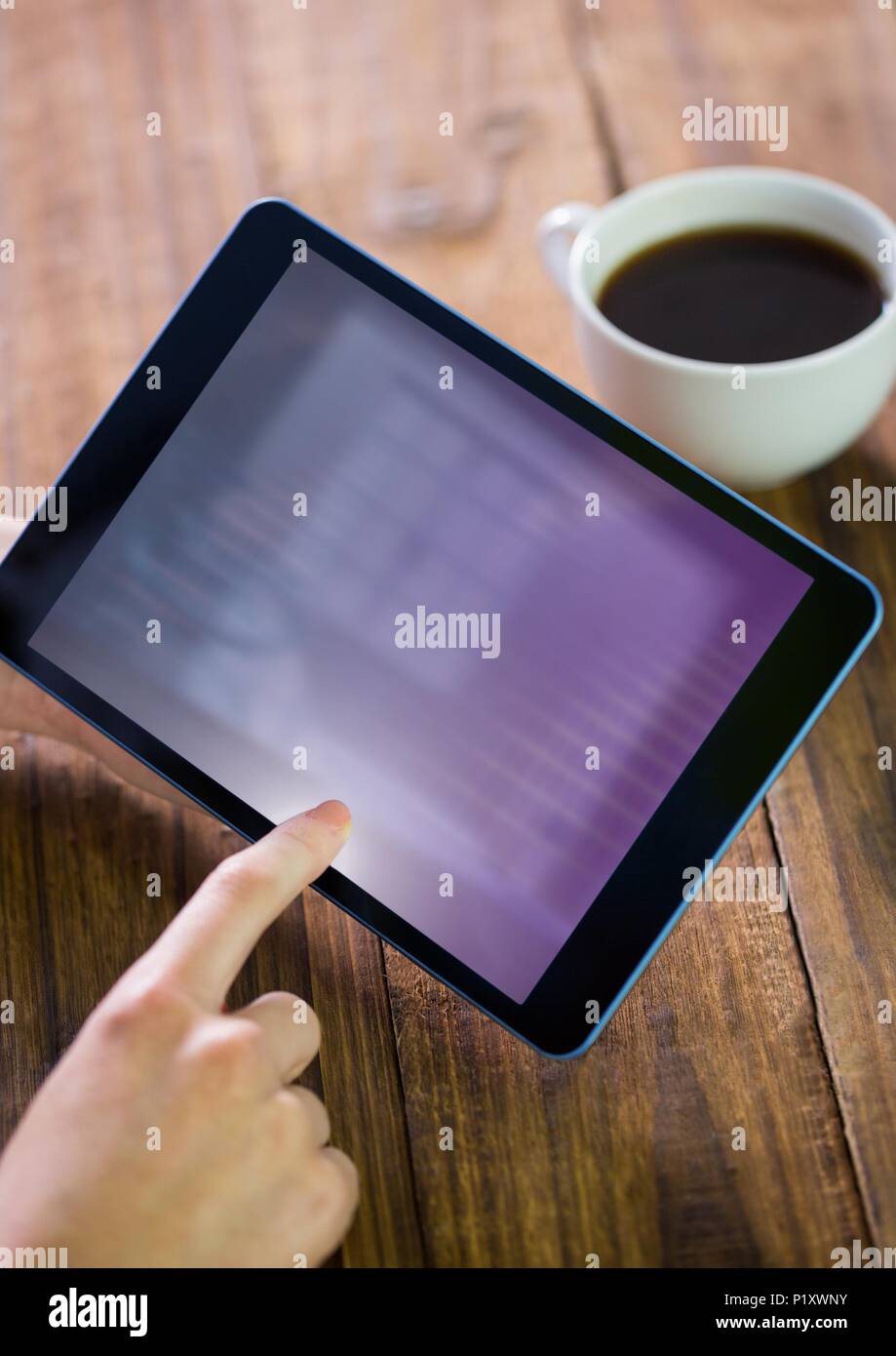 Using tablet hand table hi-res stock photography and images - Alamy