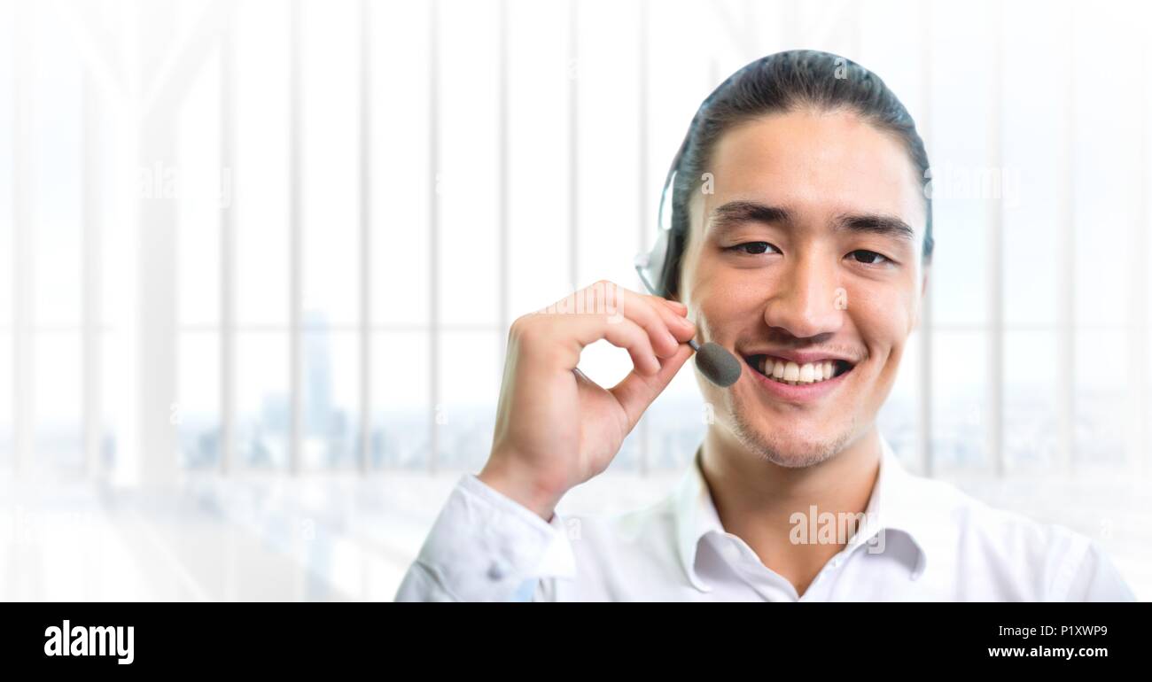 Customer service man with bright background in call center Stock Photo ...
