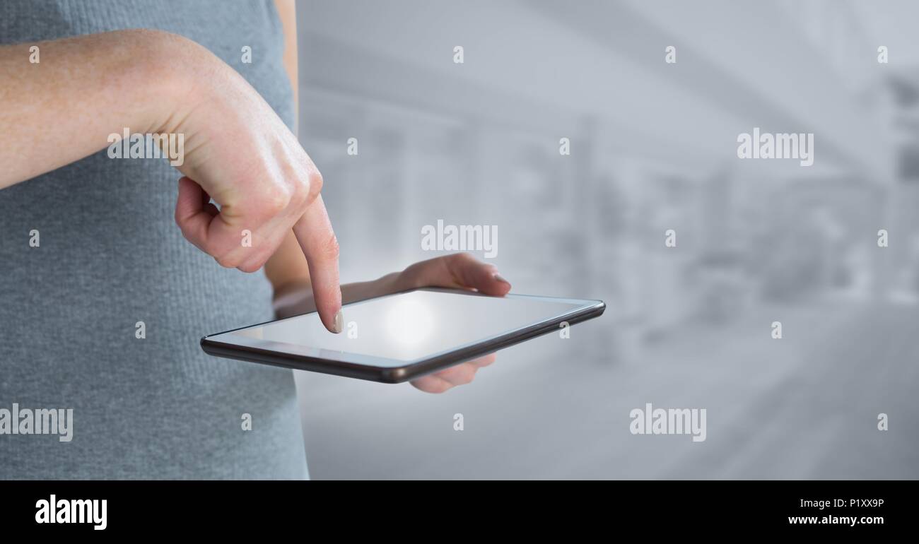 Hand using tablet with grey background Stock Photo - Alamy