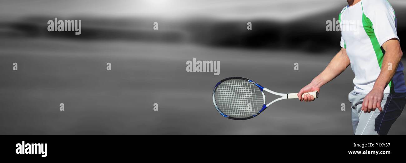 Tennis player man with grey background with racket Stock Photo - Alamy