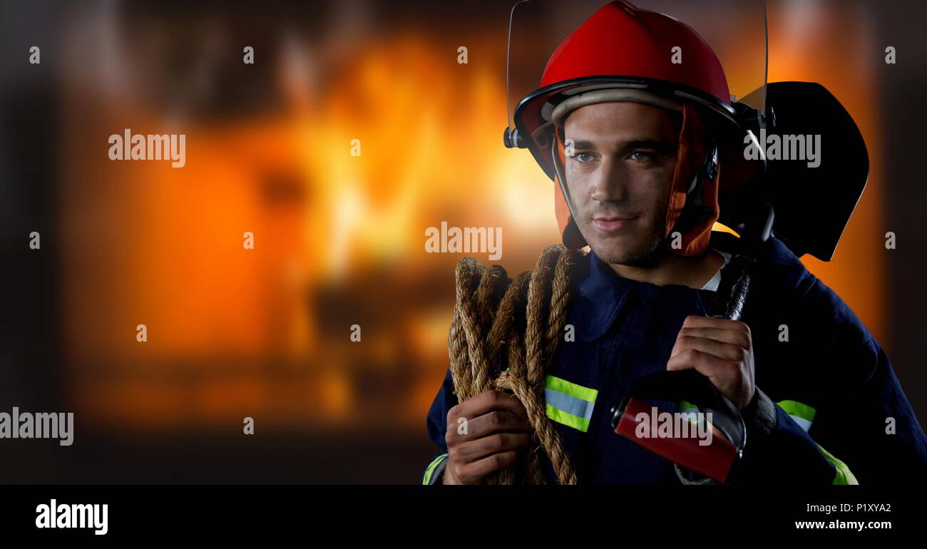 Firefighter in front of burning fire Stock Photo - Alamy