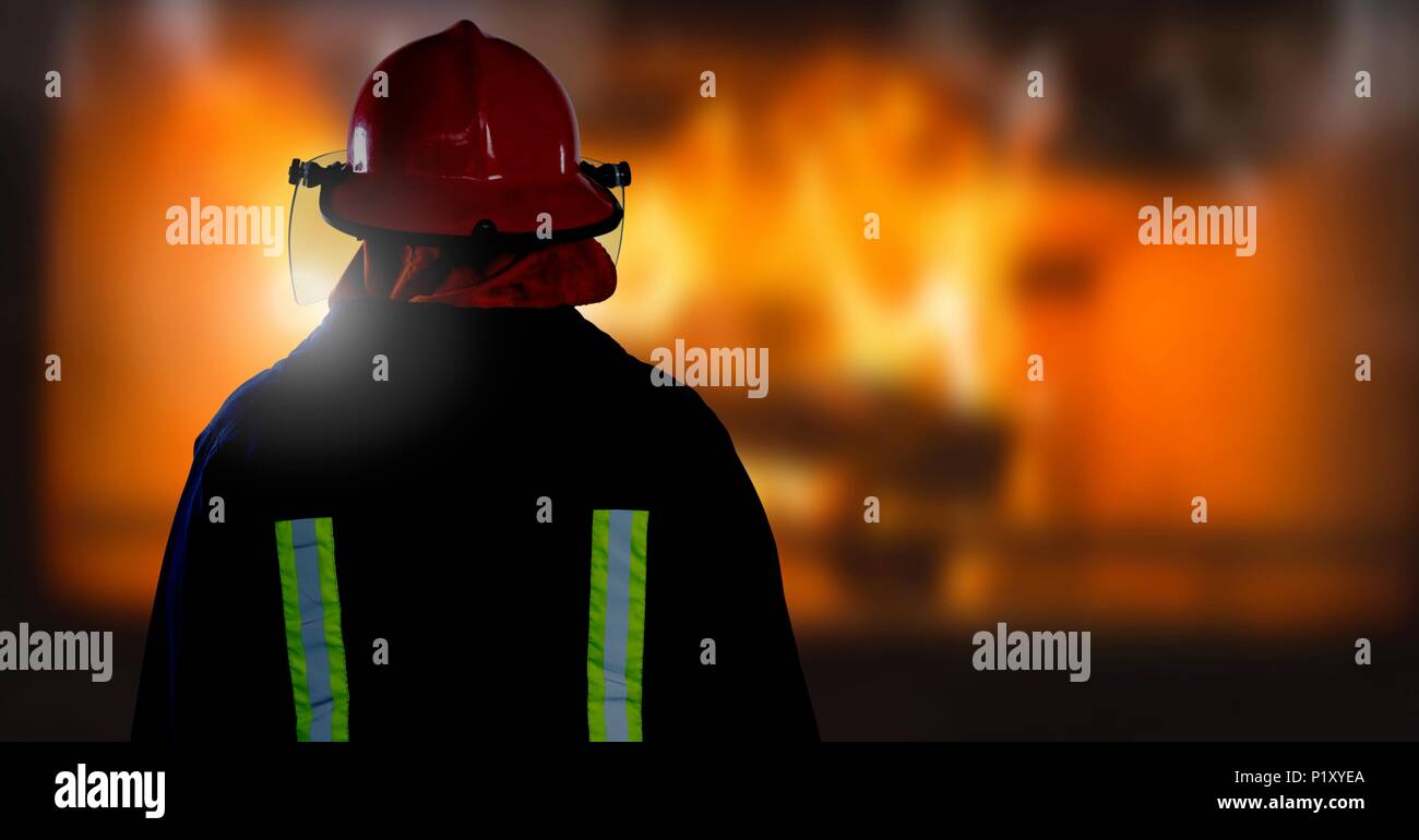 Firefighter in front of burning fire Stock Photo - Alamy