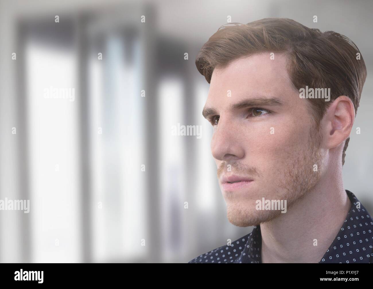 Man looking determined by window Stock Photo - Alamy