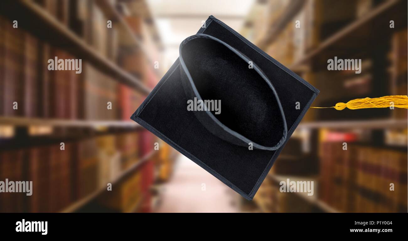 Graduation hat in education library Stock Photo - Alamy