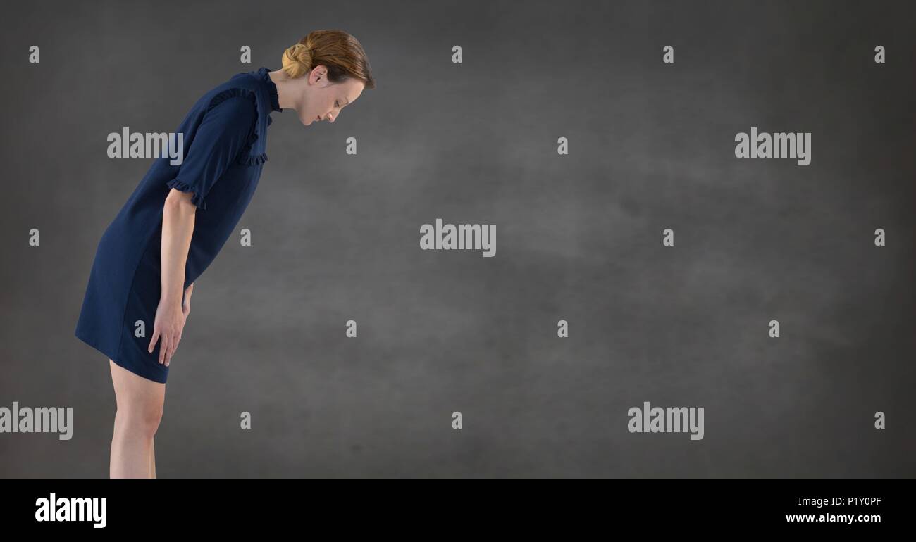 Woman looking down with grey background Stock Photo - Alamy