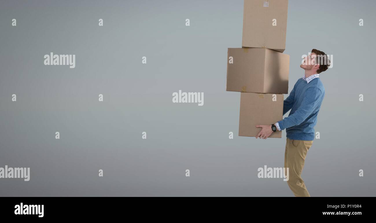Man holding delivery boxes with grey background Stock Photo - Alamy