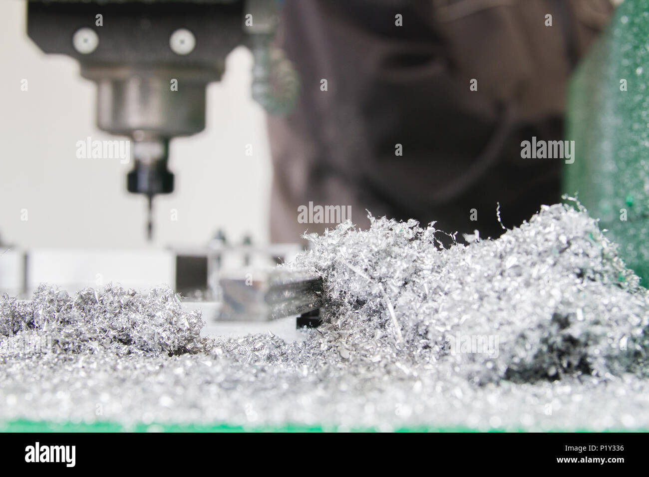 Industrial machine at factory and metal shavings at metal-working ...