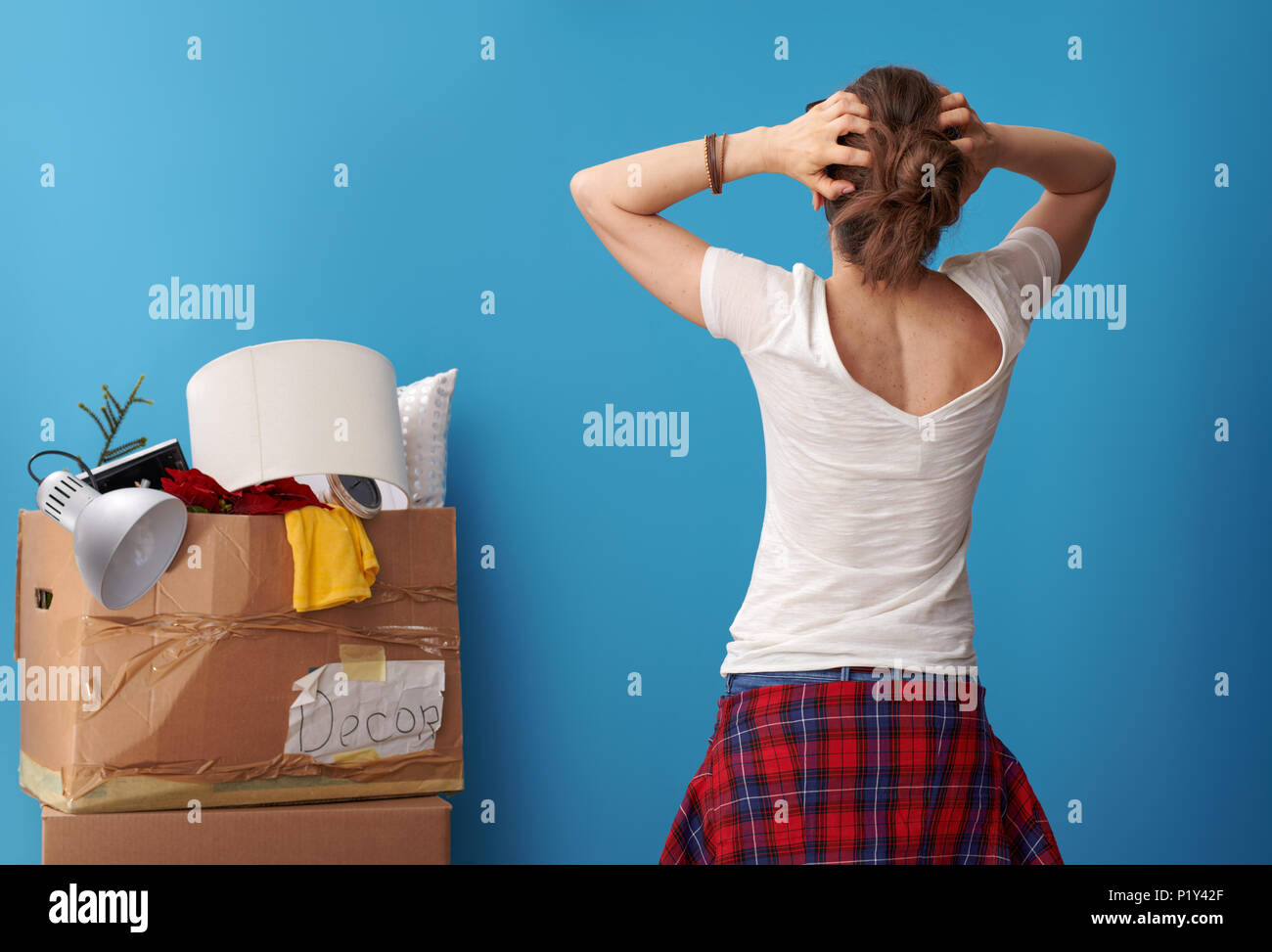 Sad woman packing boxes hi-res stock photography and images - Alamy