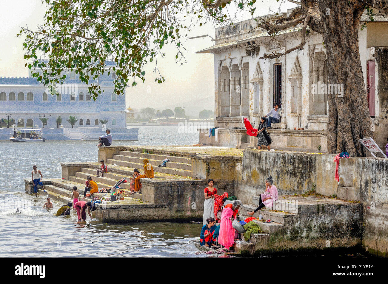 India, Rajasthan, Udaipur, bathing and doing the laundry on a ghat ...