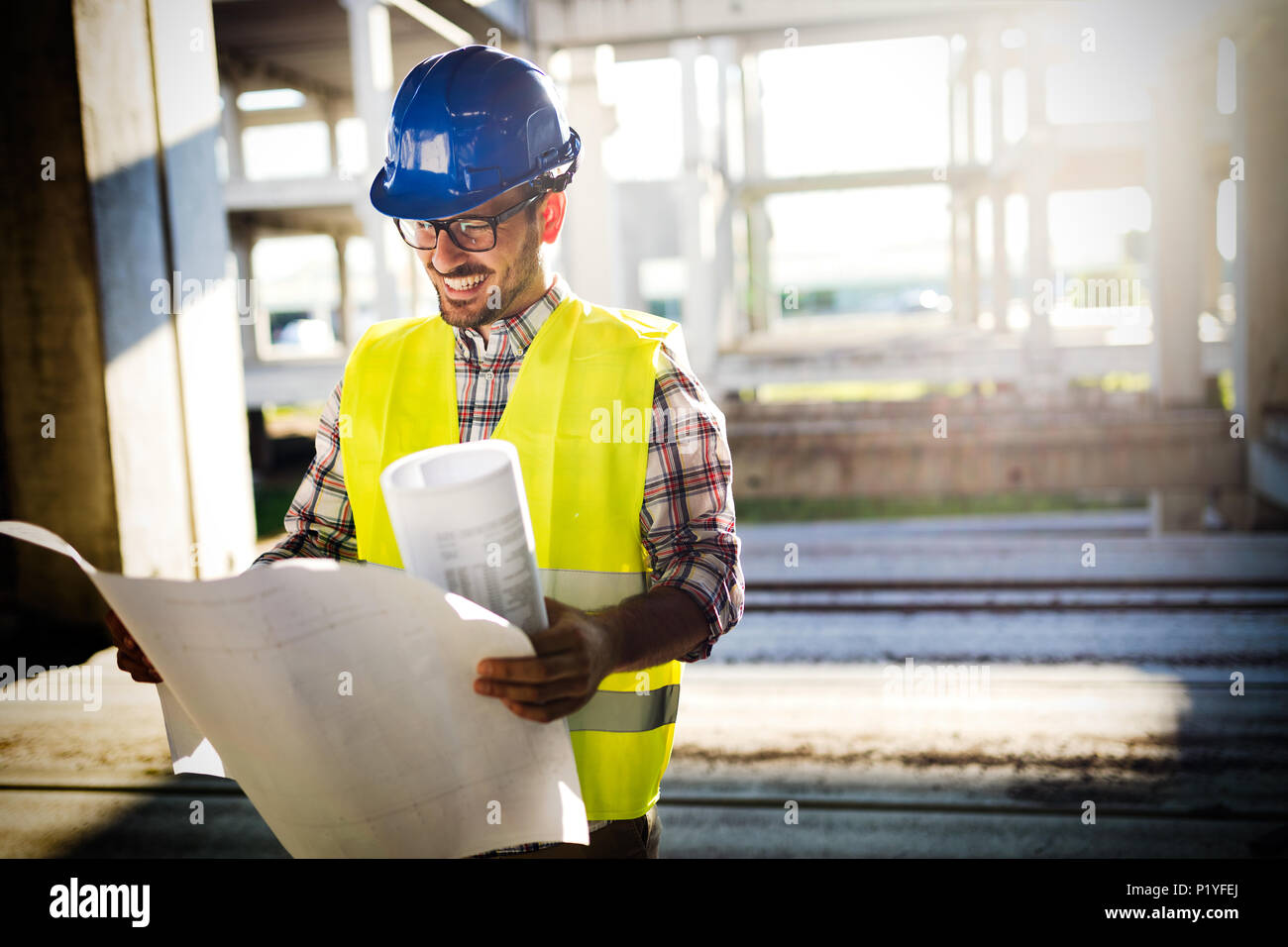 Picture of construction site engineer looking at plan Stock Photo - Alamy