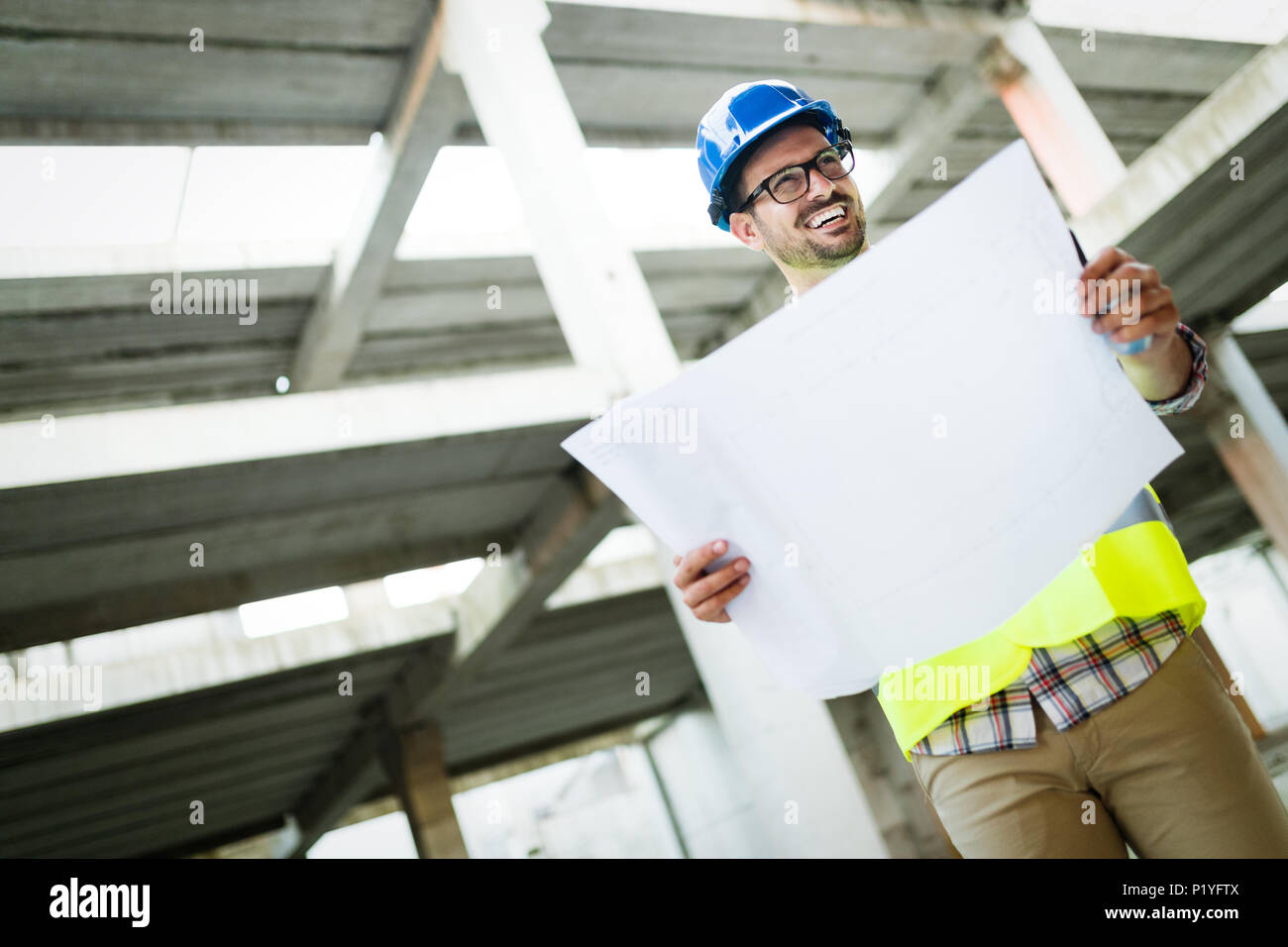 Picture of construction site engineer looking at plan Stock Photo - Alamy
