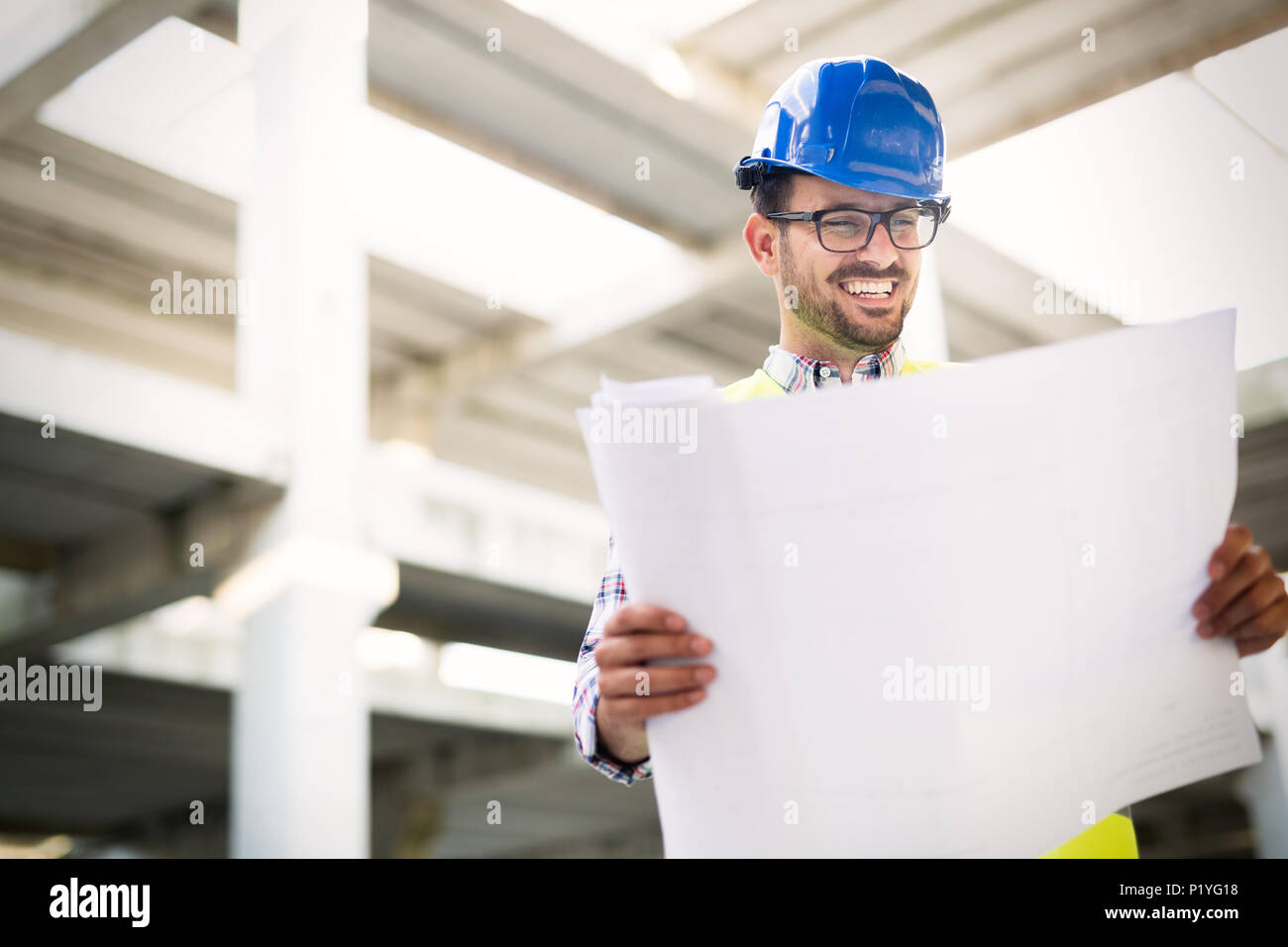Picture of construction site engineer looking at plan Stock Photo - Alamy
