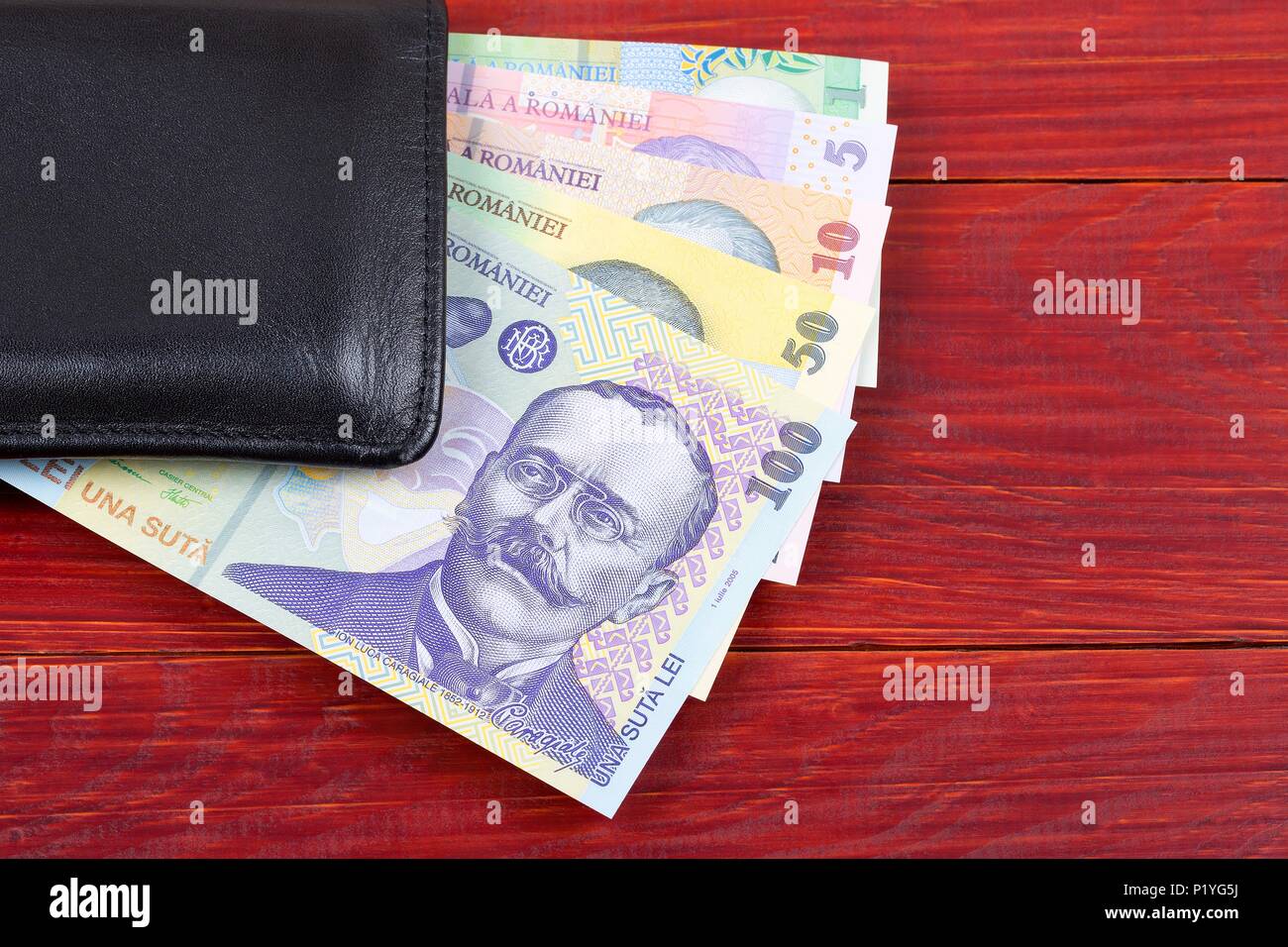 Money from Romania in the black wallet Stock Photo - Alamy