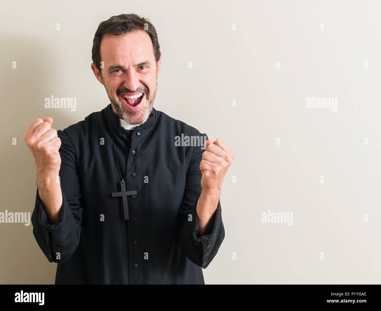 Senior priest religion man screaming proud and celebrating victory and ...
