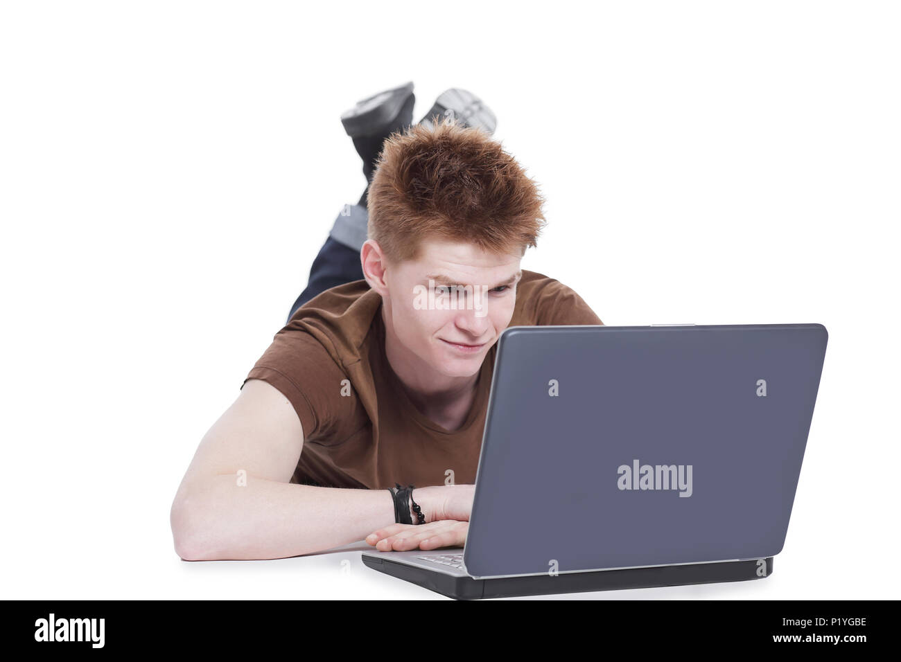 closeup. modern guy working on laptop lying on the floor Stock Photo ...