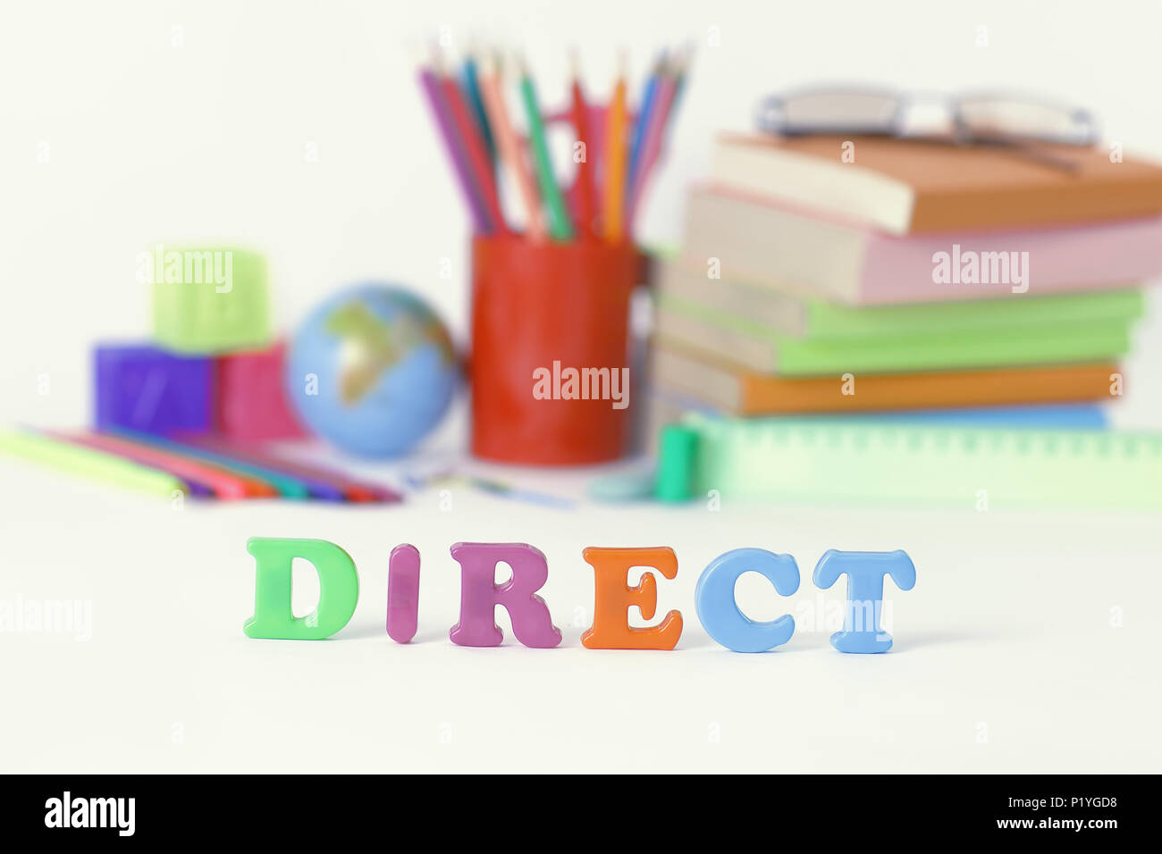 word direct on blurred background of school supplies .photo with copy ...