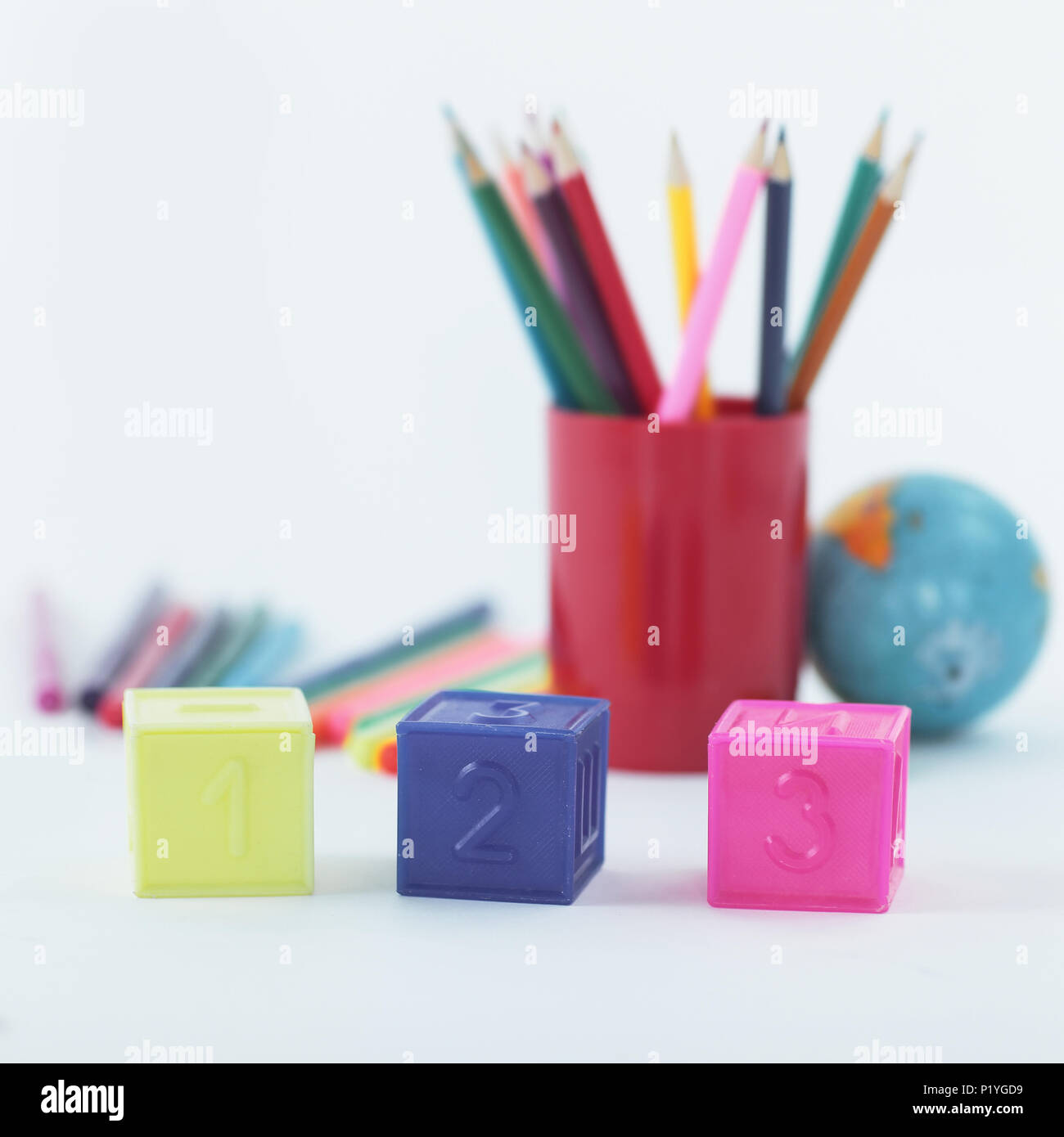 cubes with numbers on blurred school supplies background Stock Photo ...