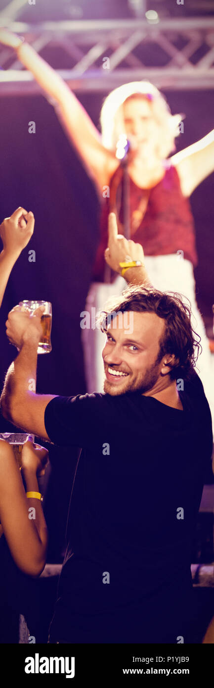 Cheerful fans with female performer on stage Stock Photo - Alamy