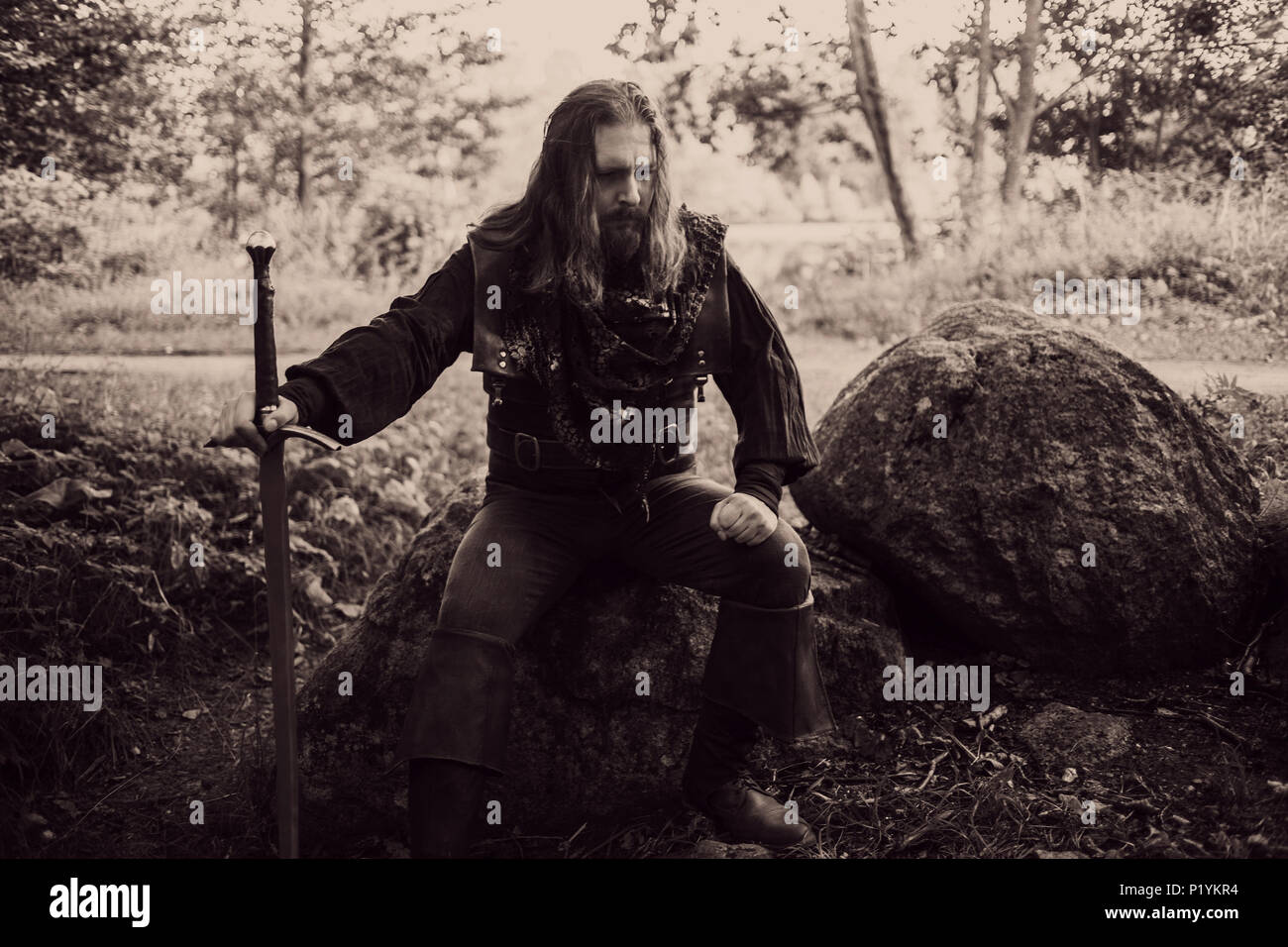 The bearded man knight. A guy in a medieval costume with a sword Stock ...