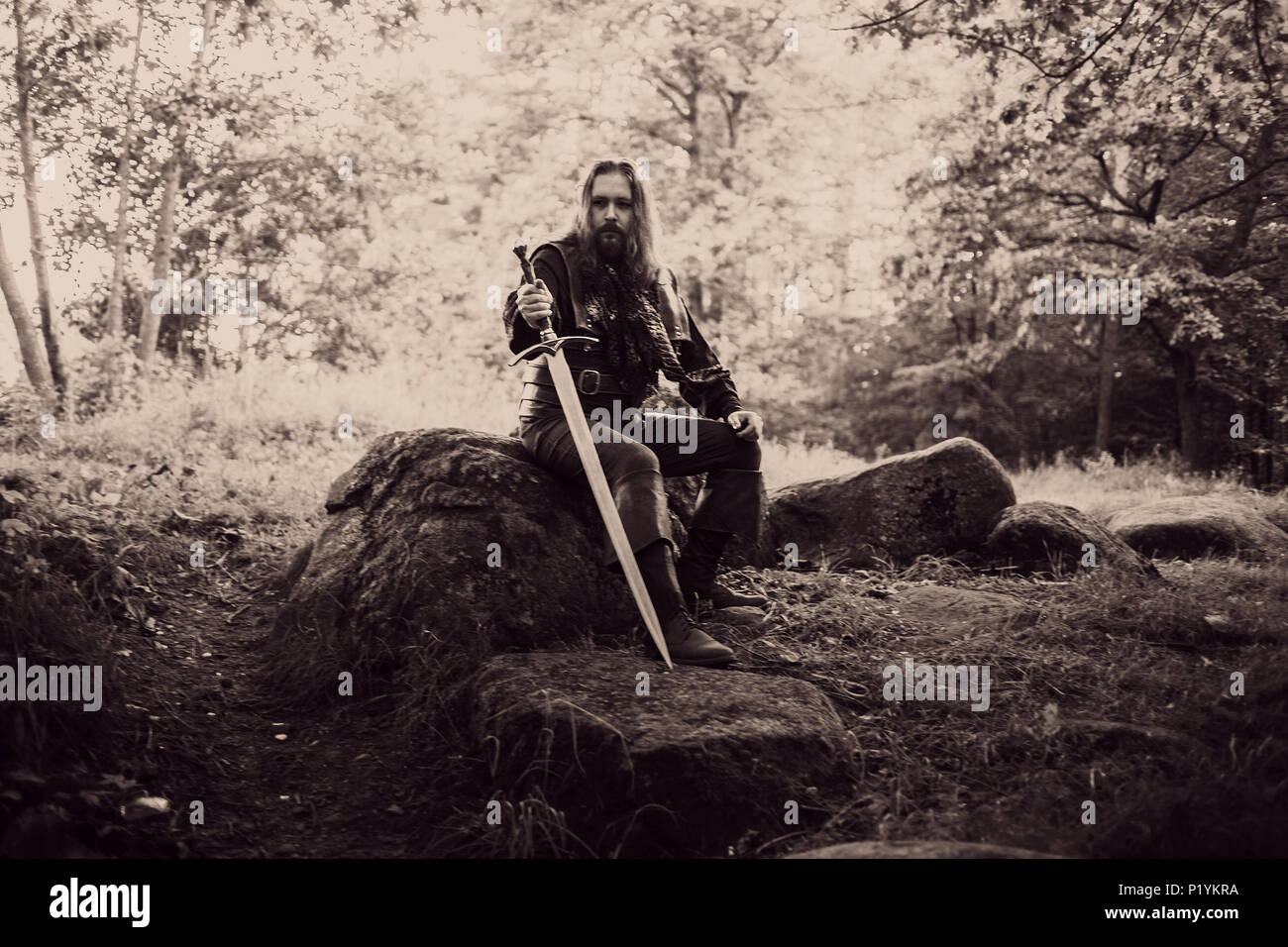 The bearded man knight. A guy in a medieval costume with a sword Stock ...