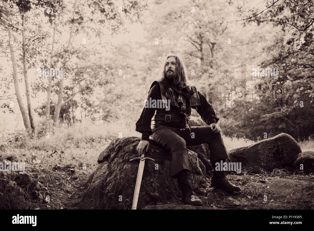 The bearded man knight. A guy in a medieval costume with a sword Stock ...