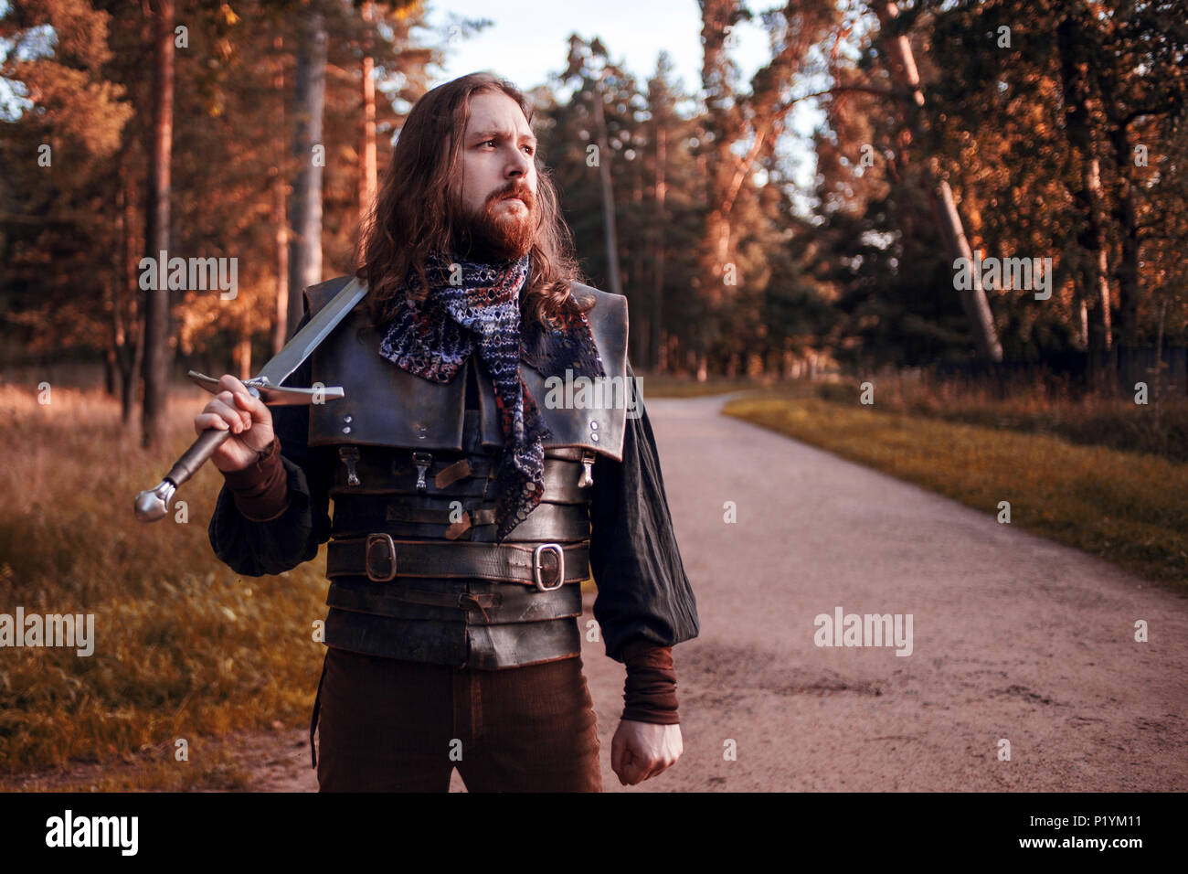 The bearded man knight. A guy in a medieval costume with a sword Stock ...