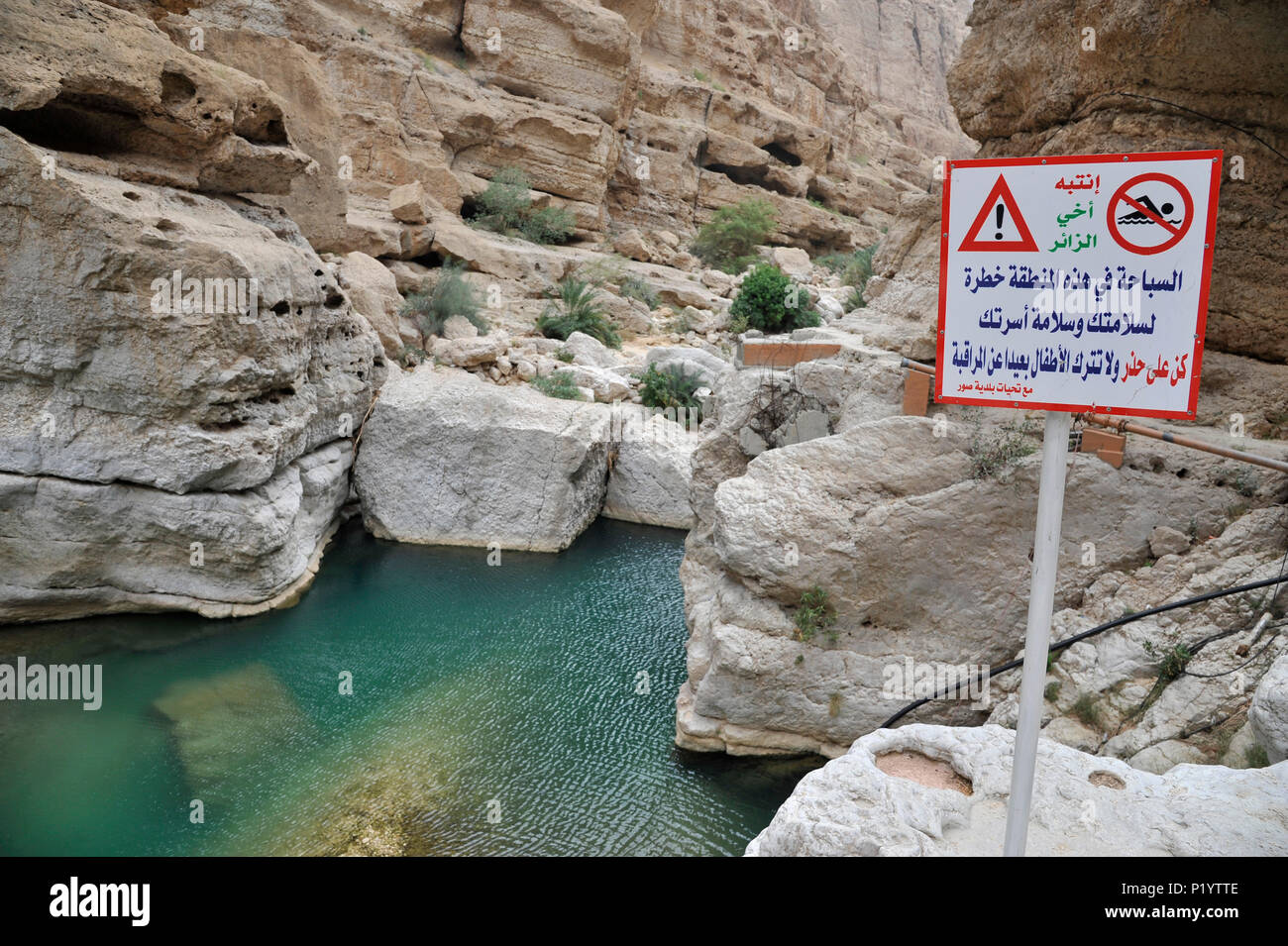 Sultanate of Oman, Wadi Shab, a sign written in arabic warn about the ...