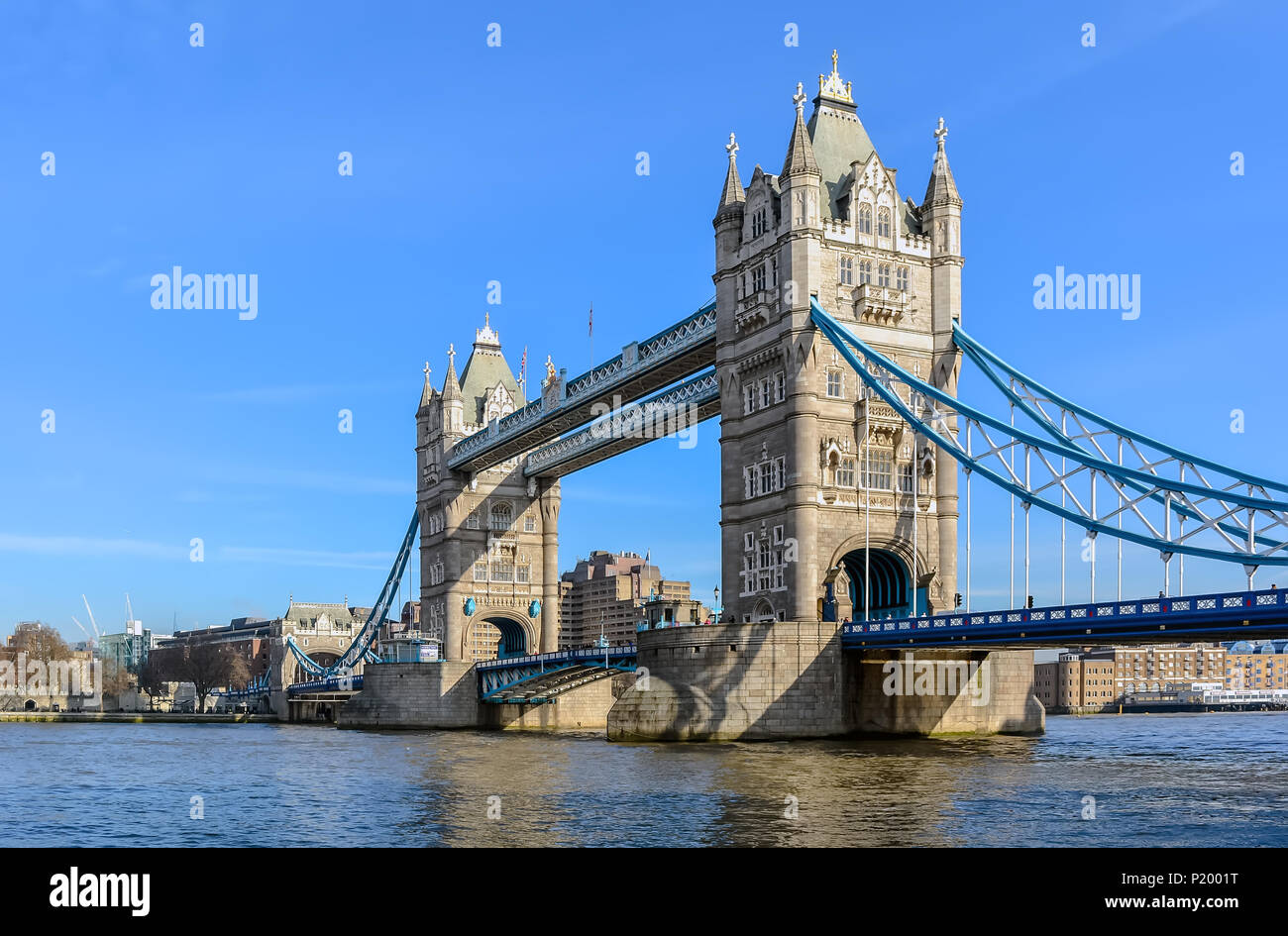 Tower Bridge against the winter blue sky. The bascule and suspension ...