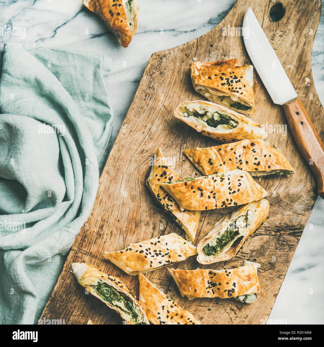 Freshly baked Turkish borek roll cut in slices, square crop Stock Photo ...
