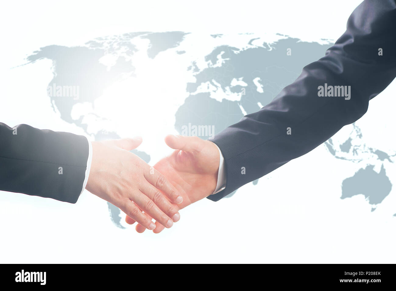 Handshake with map of the world in background Stock Photo - Alamy