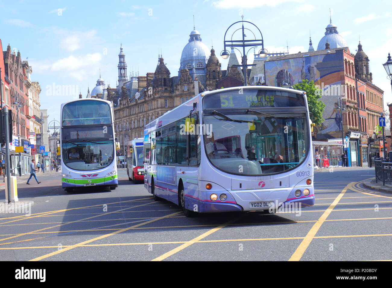 Buses from the First Bus Company drive along New Market Street in Leeds ...