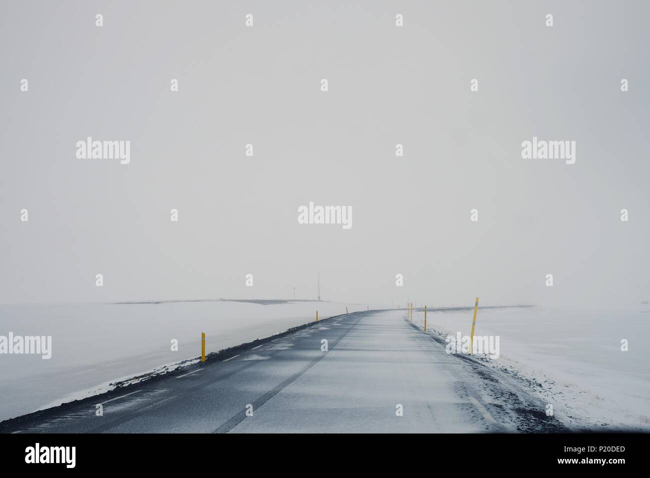 Road disappearing into white fog and snow Stock Photo - Alamy