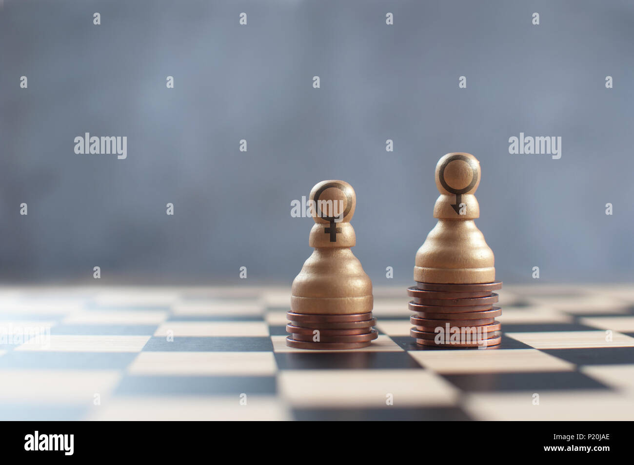 Two chess pawns on top of a heap of coins with varying heights Stock ...