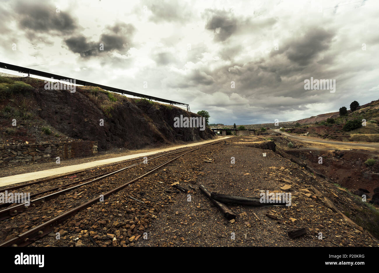 Old railroad track in the mines, with pebbles and burned woods on the ...