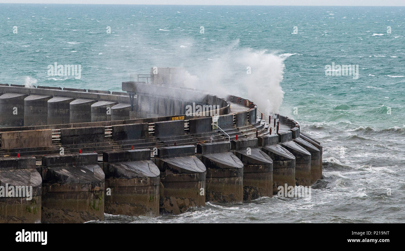Brighton UK 14th June 2018 - Waves crash over Brighton Marina wall as ...