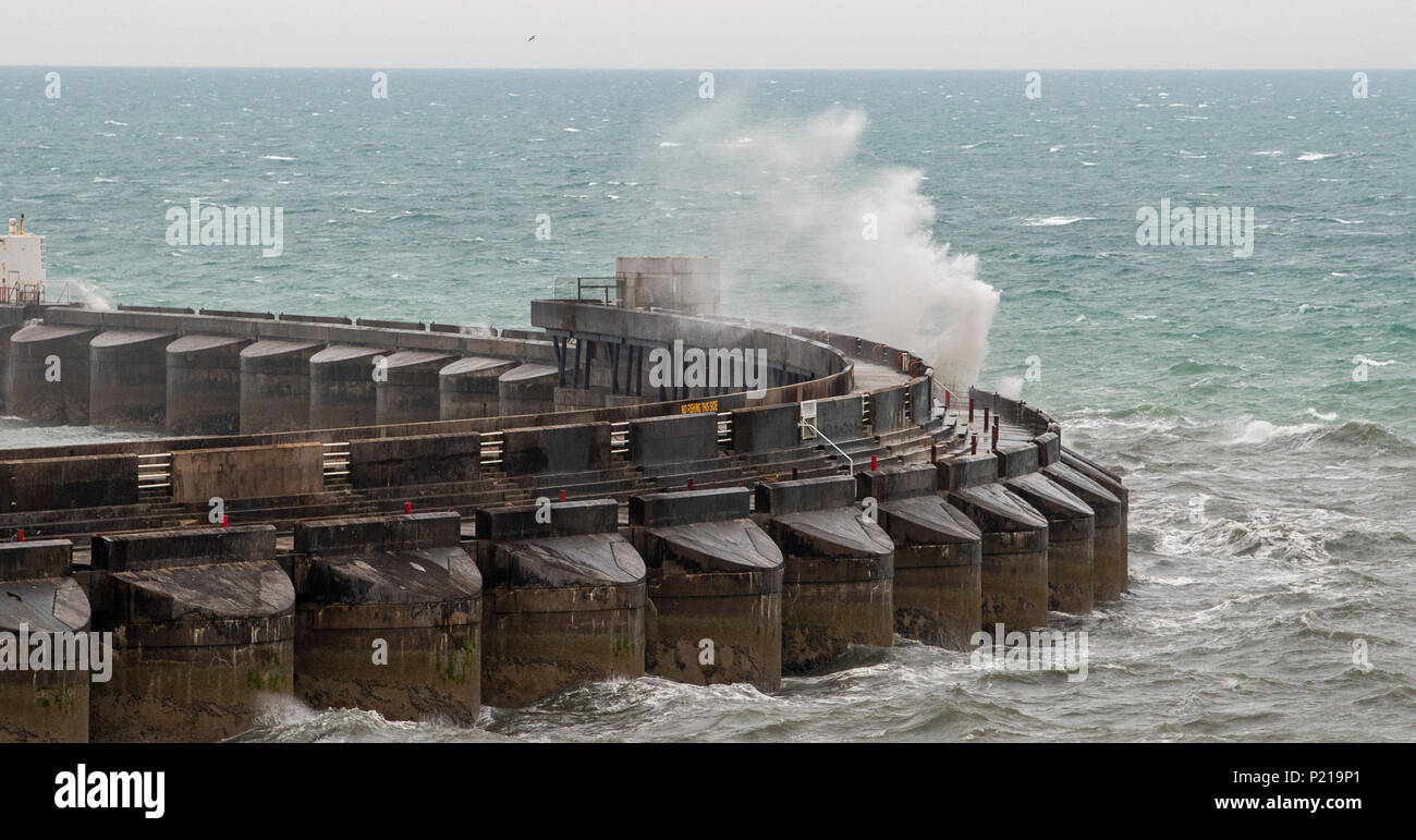 Brighton UK 14th June 2018 - Waves crash over Brighton Marina wall as ...