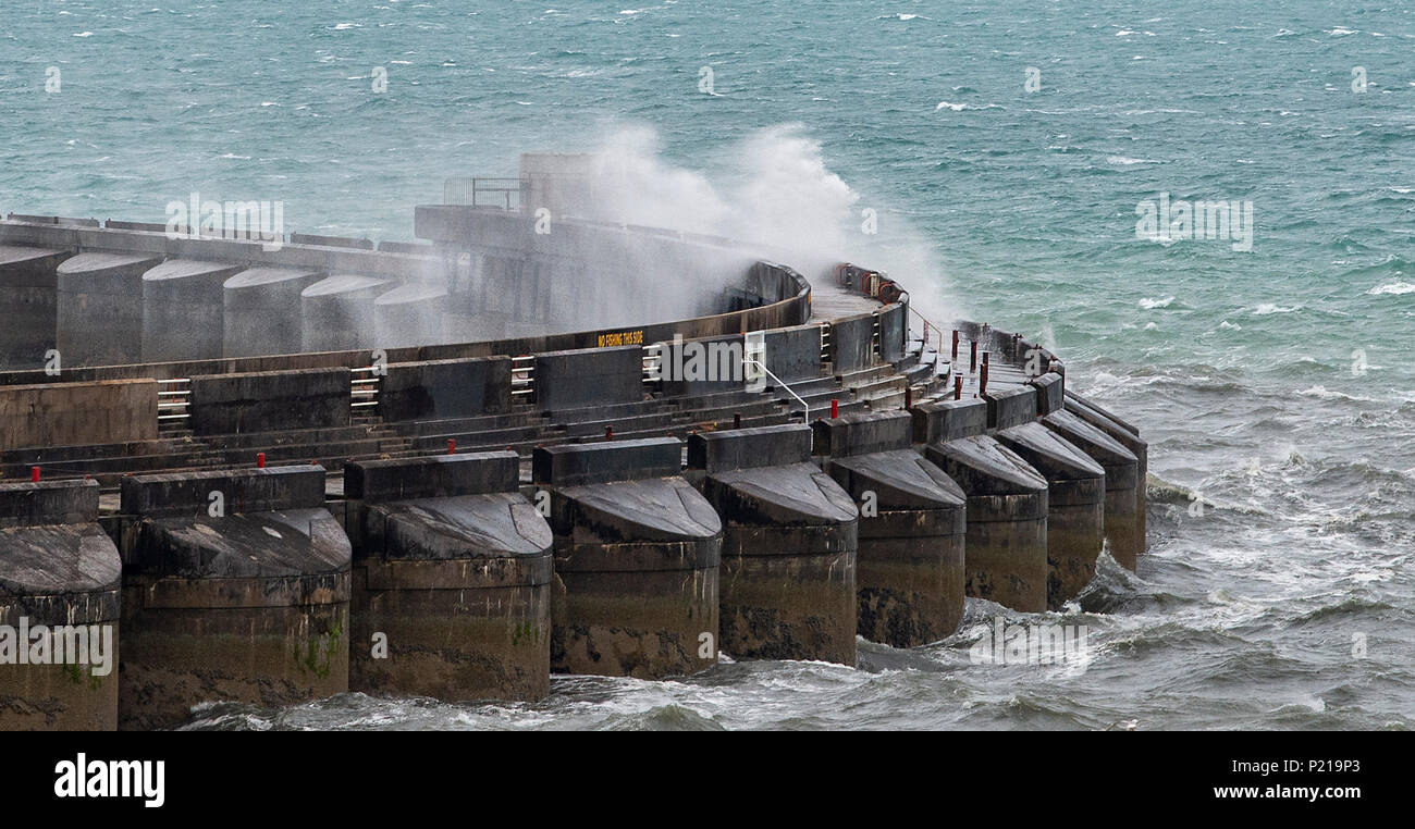 Brighton UK 14th June 2018 - Waves crash over Brighton Marina wall as ...