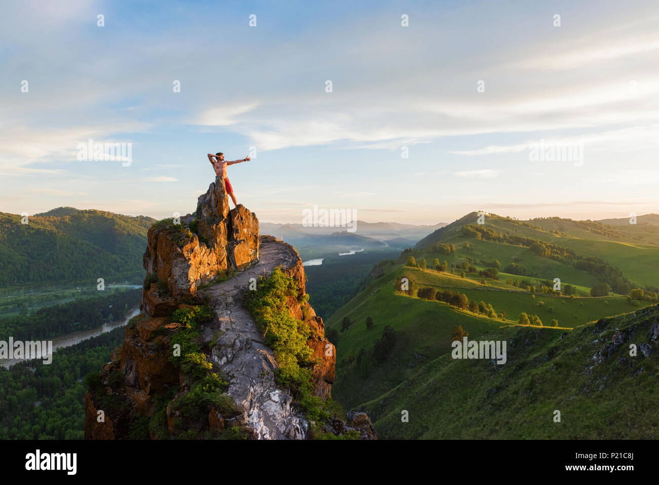 Man standing on top of cliff Stock Photo - Alamy