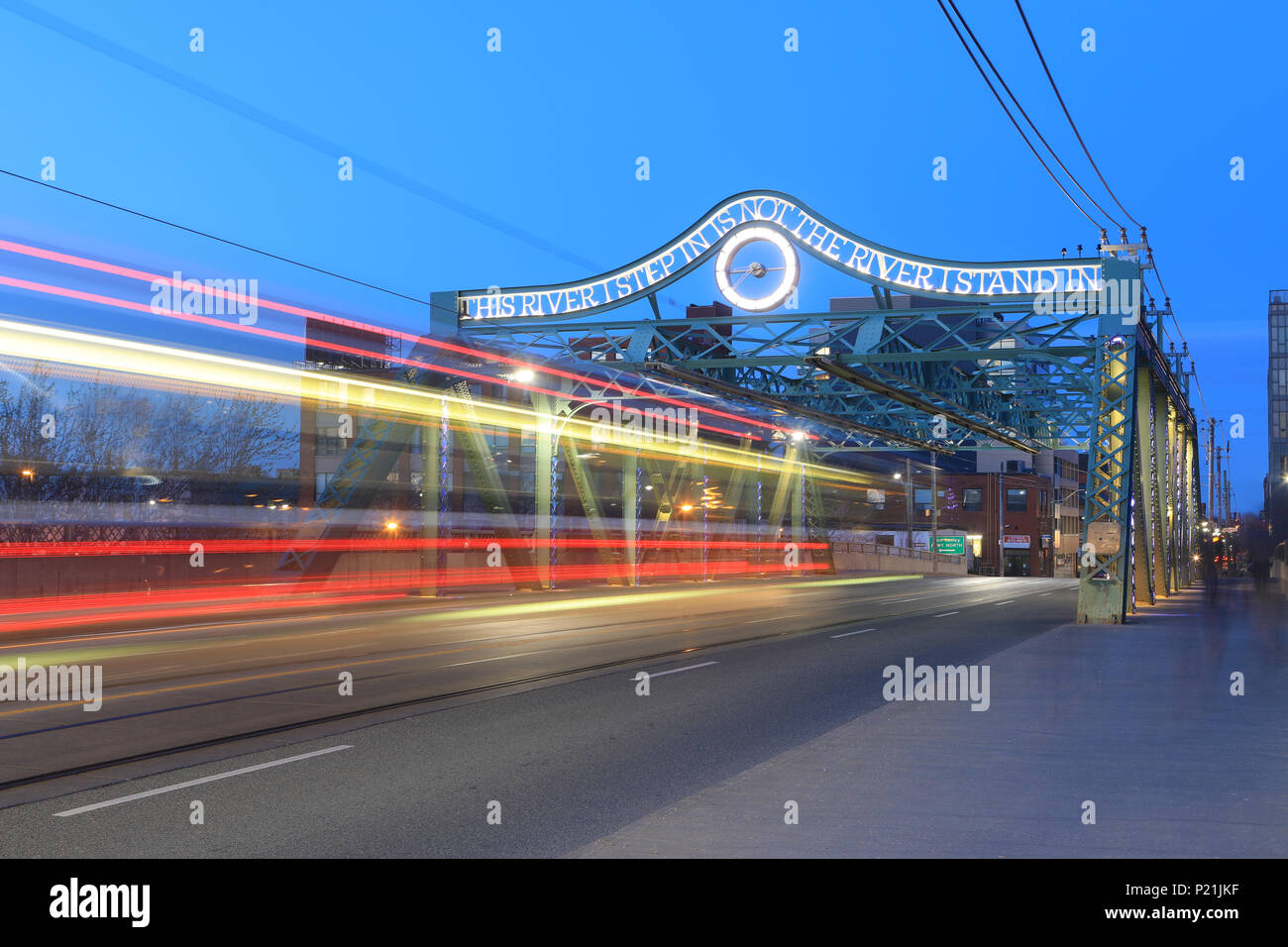 The Queen Street Bridge in Toronto at twilight with traffic light ...
