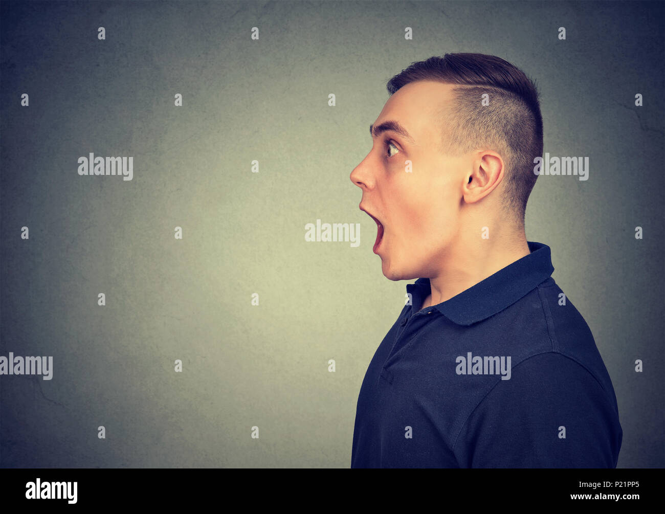 Shocked dazed young man isolated on gray background Stock Photo - Alamy