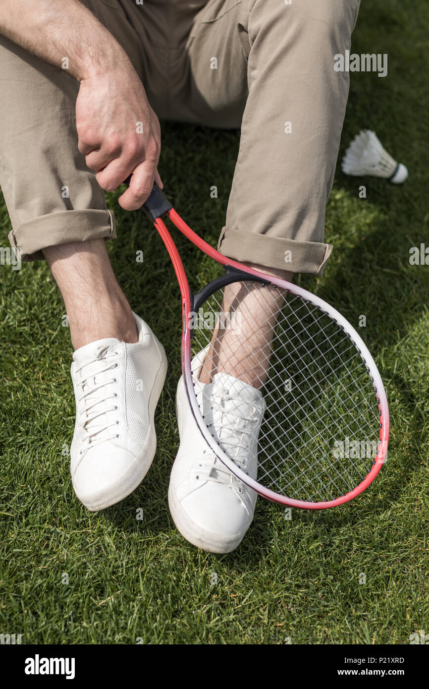 cropped shot of man holding badminton racket in hand Stock Photo - Alamy
