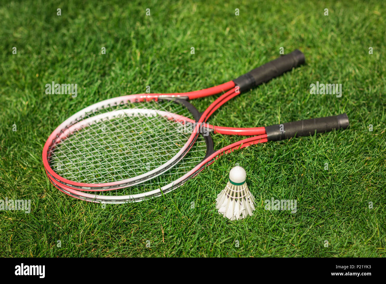 close up of badminton rackets with shuttlecock on grass Stock Photo - Alamy