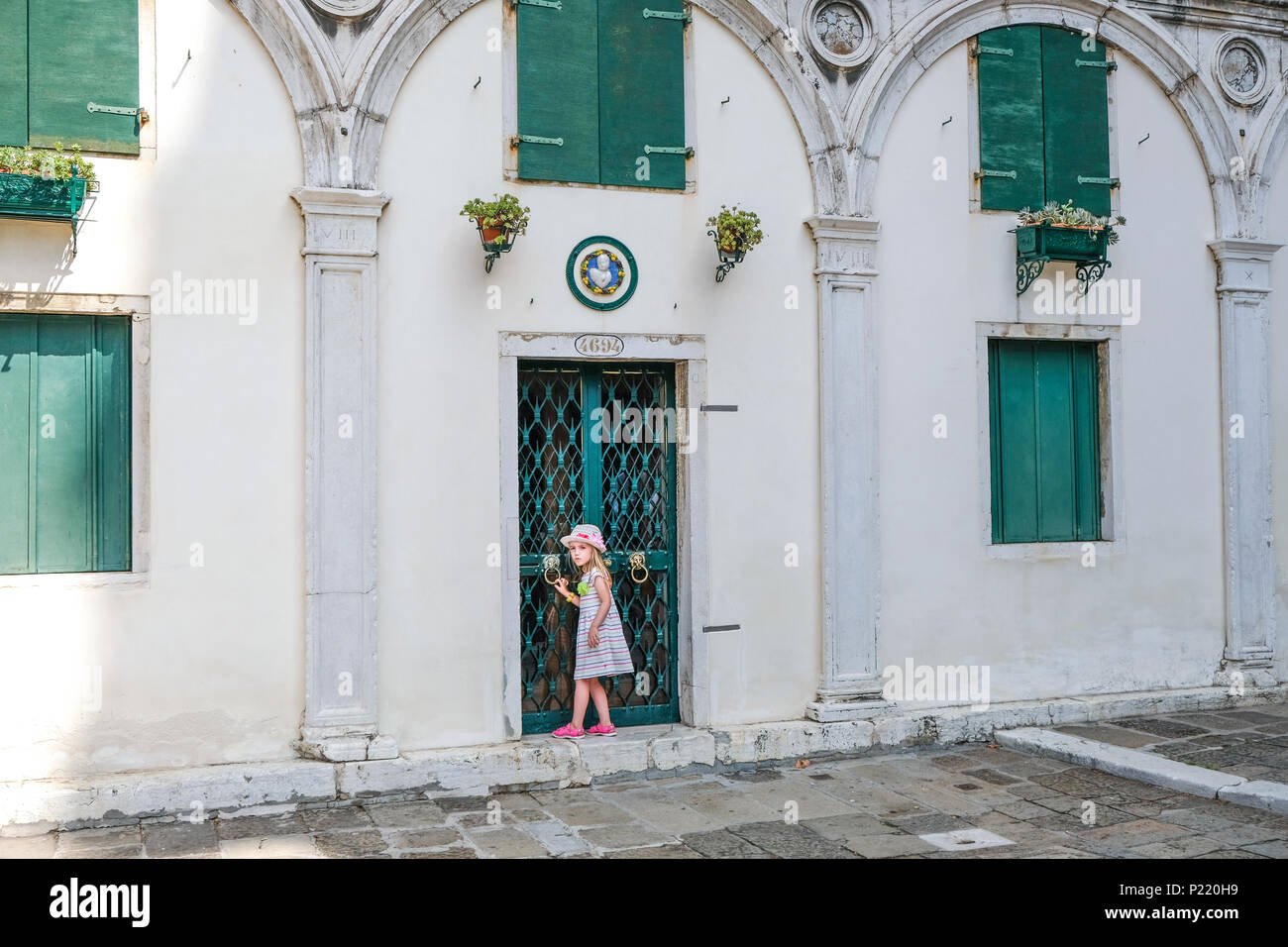 Young girl explores the quiet squares and Piazzas in Venice, Italy. A ...