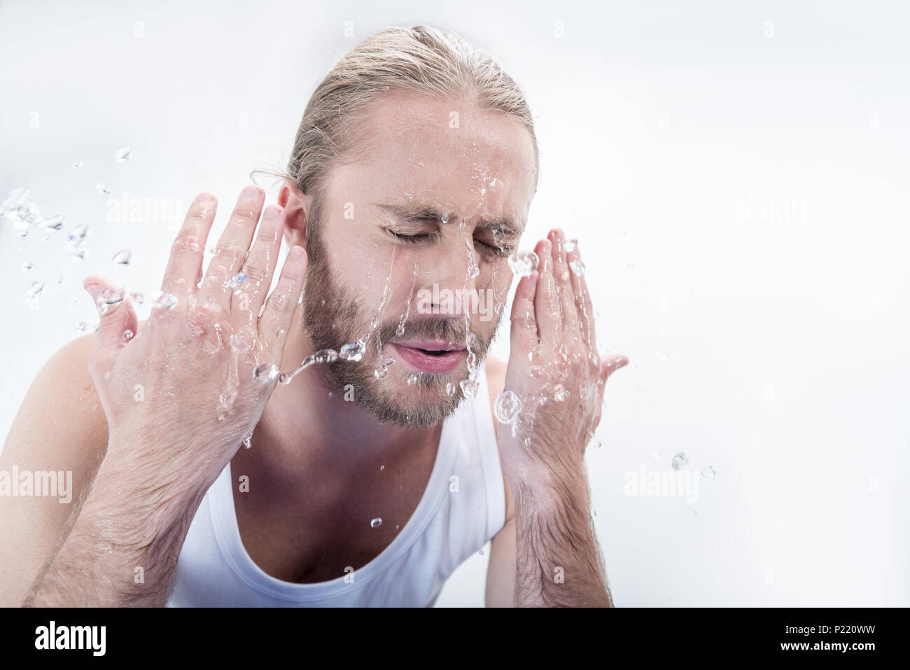 Young man washing face hi-res stock photography and images - Alamy