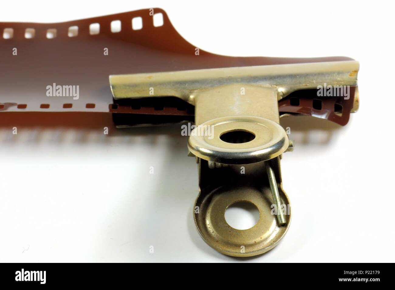 Film strip on a white background with metal clip Stock Photo - Alamy
