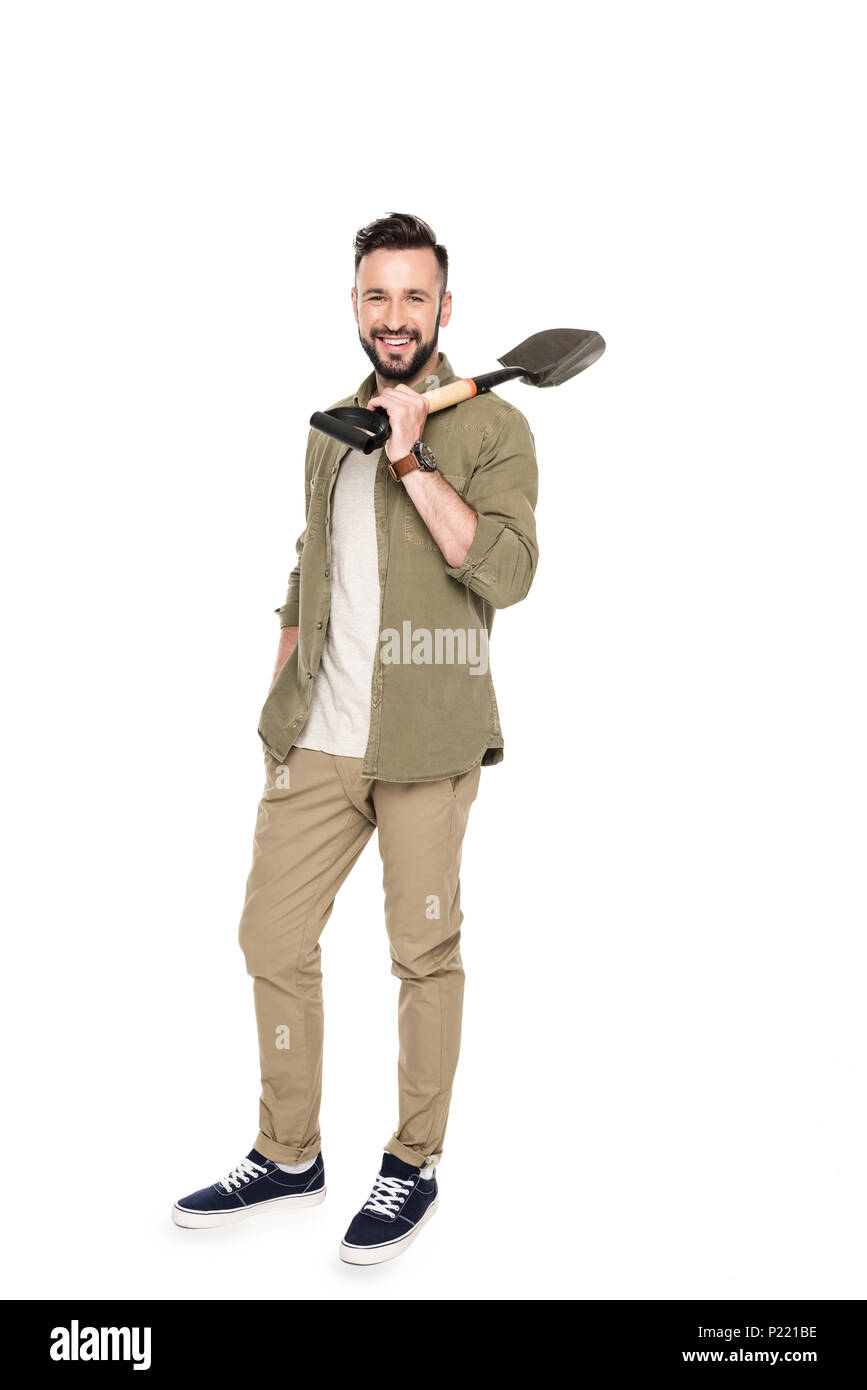 smiling man holding shovel on his shoulder and looking at camera ...