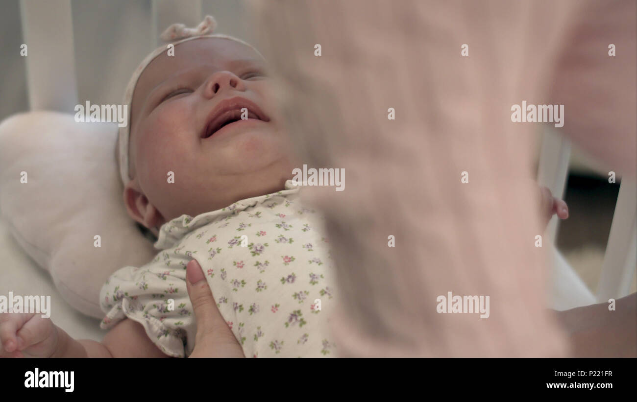 crying baby in bed Stock Photo - Alamy