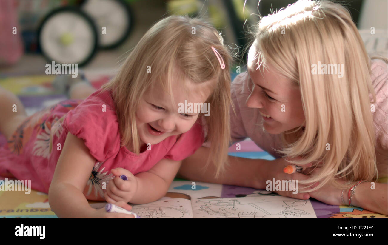 Mother and daughter writing together Stock Photo - Alamy