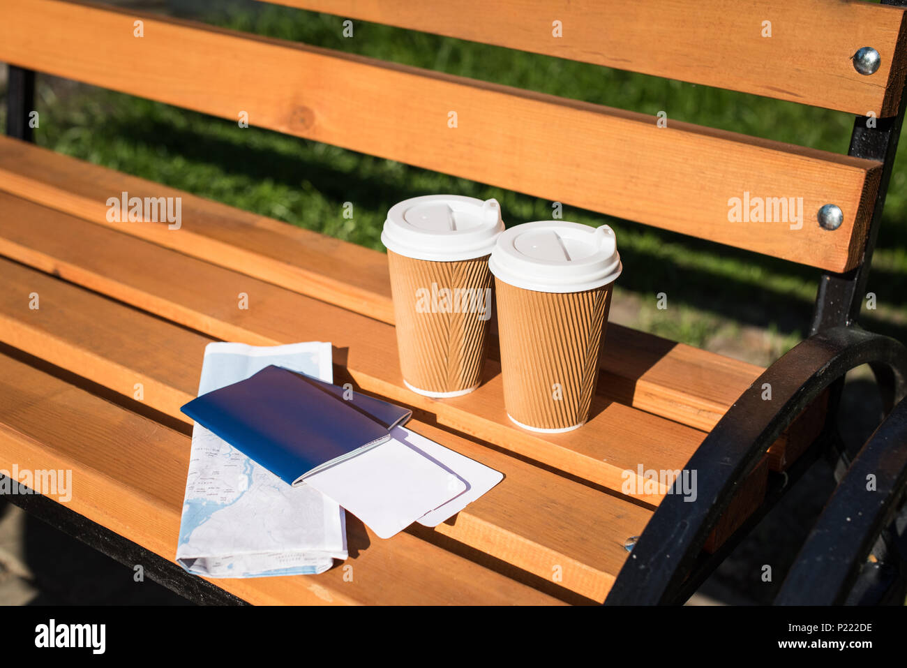 Close-up view of passports with tickets, map and disposable coffee cups ...