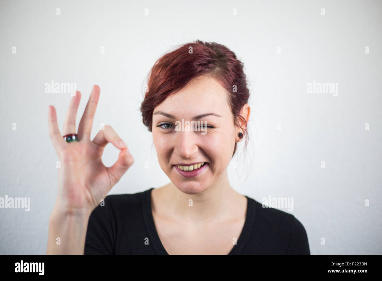 A young girl shows facial expressions that the job is done well, white ...